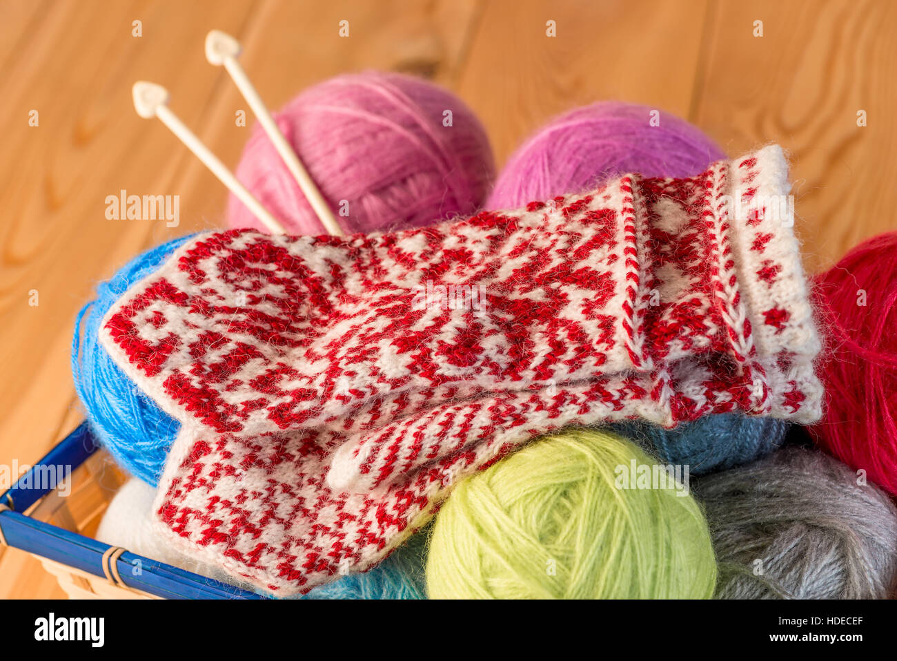 mittens handmade with beautiful pattern lie in the woolen threads Stock ...