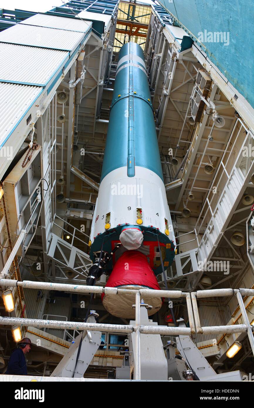 The first stage of the United Launch Alliance Delta II rocket is lifted into a stand at the ...