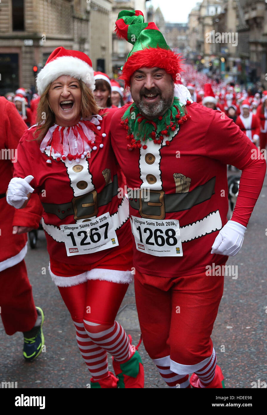 Runners in Santa costumes take part in the Glasgow Santa Dash to raise ...