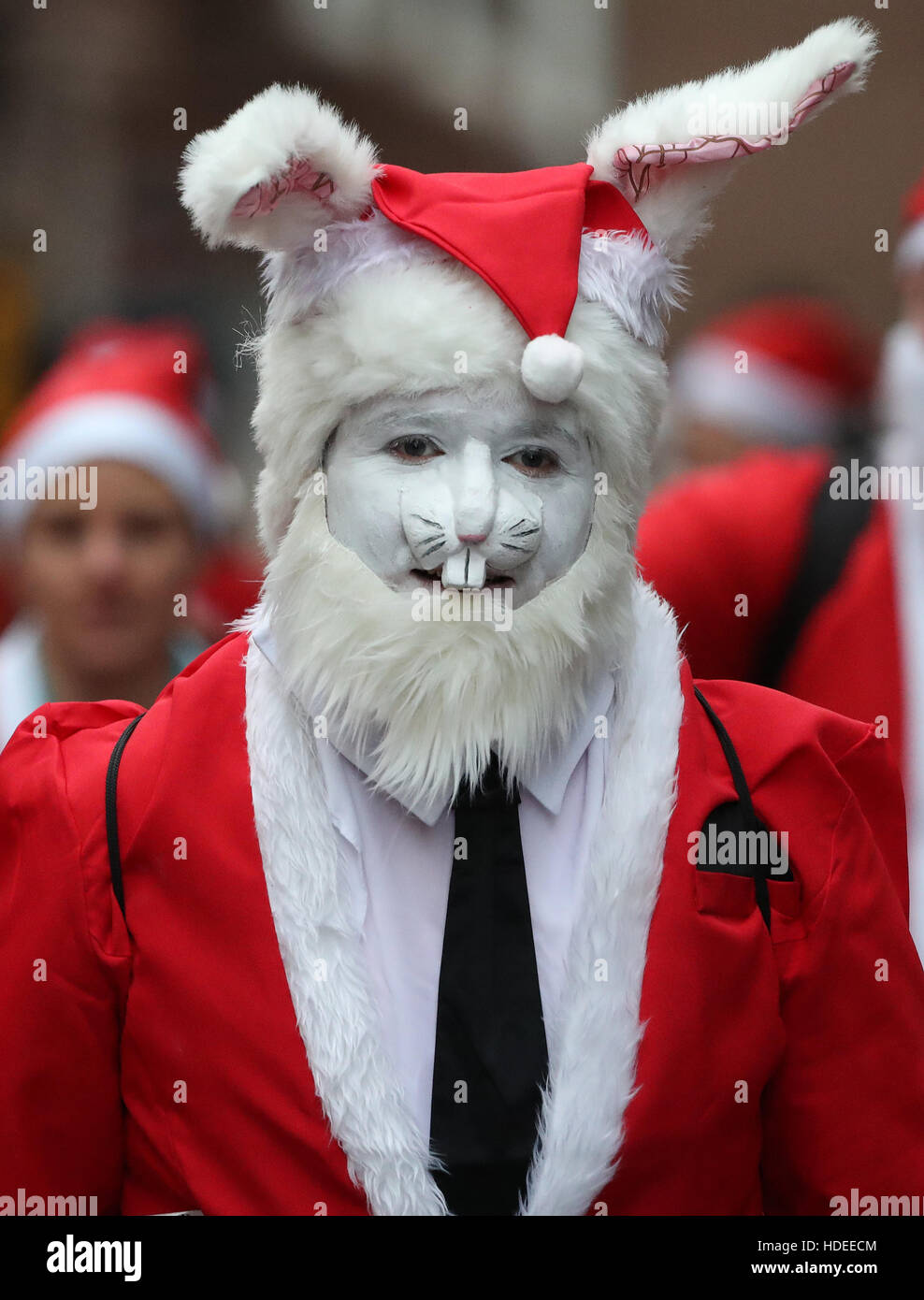 A runner in a Santa costume takes part in the Glasgow Santa Dash to ...