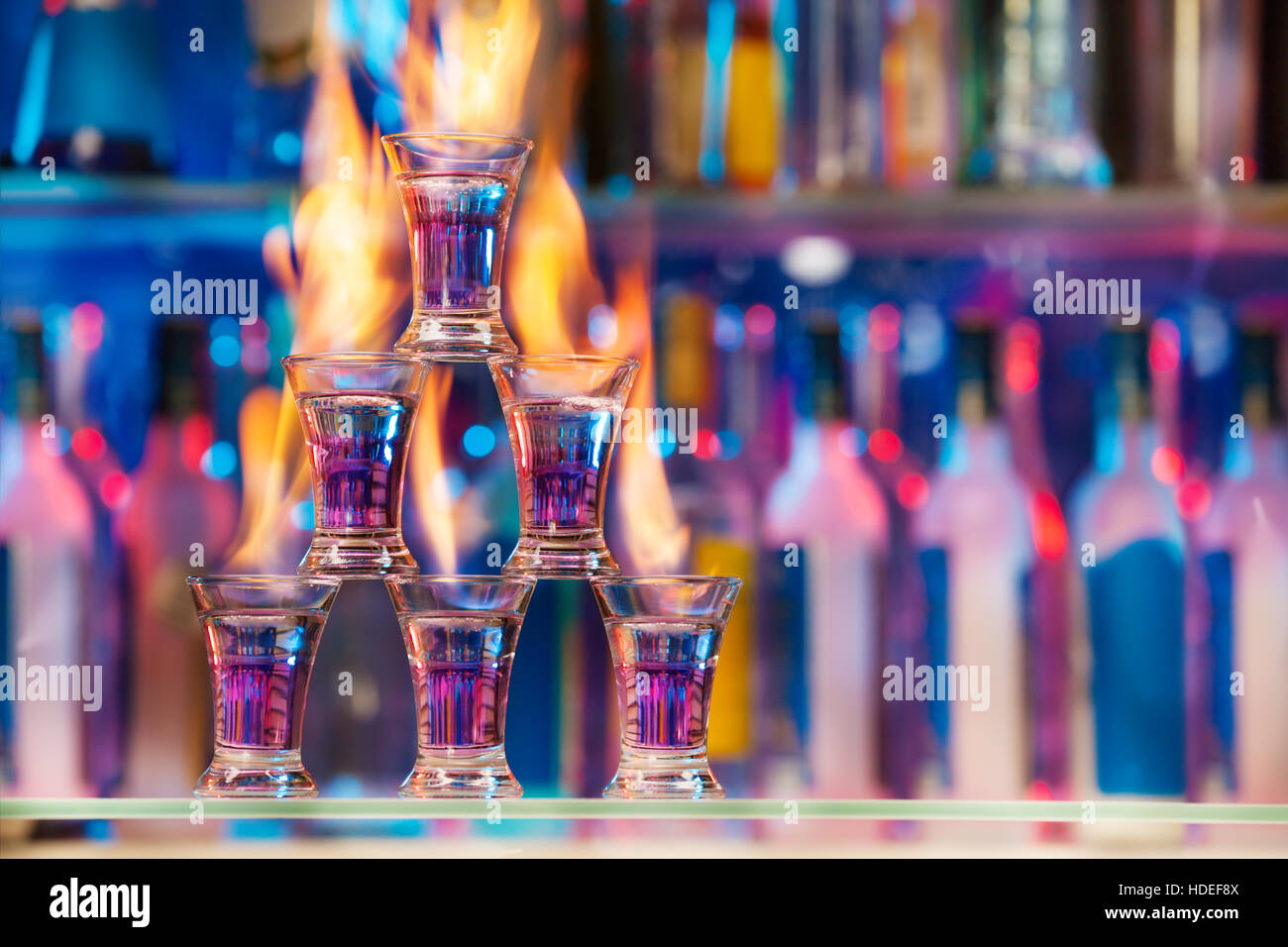 Pyramid of shot glasses with flaming cocktails Stock Photo - Alamy