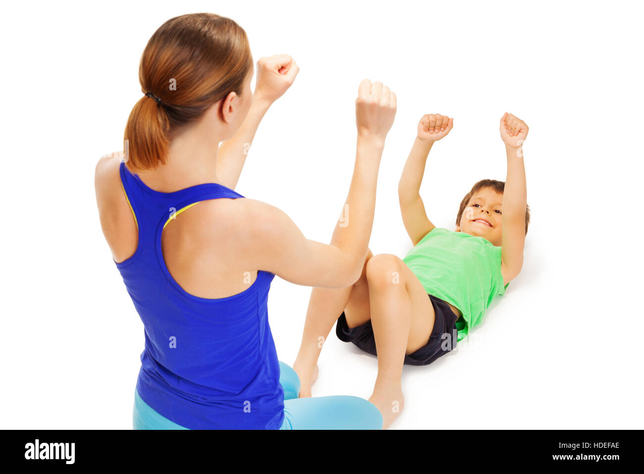 Smiling boy doing exercises with female trainer Stock Photo - Alamy