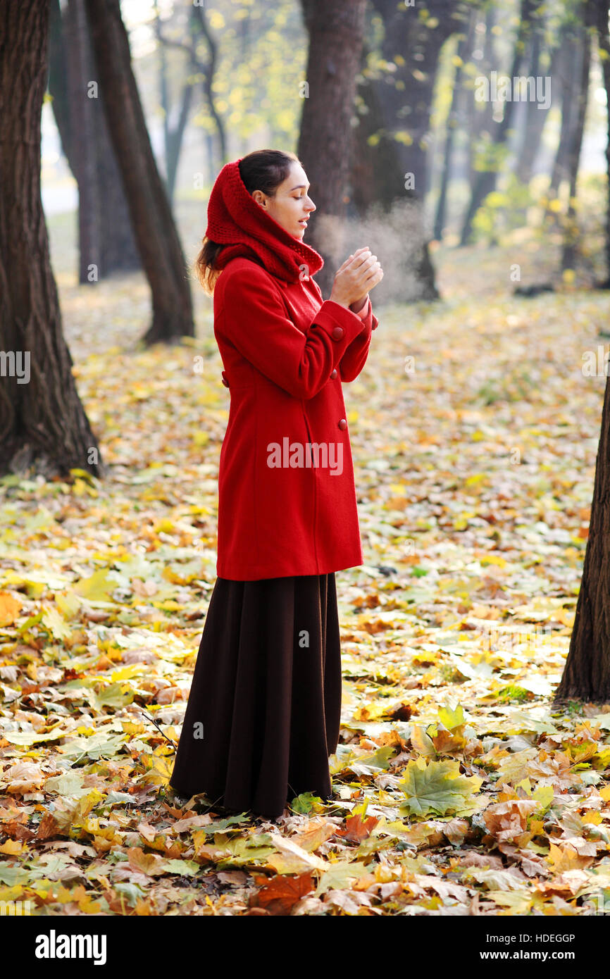 Beautiful young girl walking in autumn park Stock Photo - Alamy