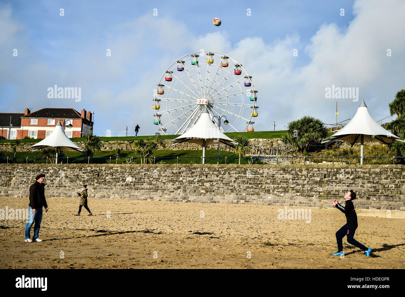 People play rugby and practice kicking on the sandy beach at Barry ...