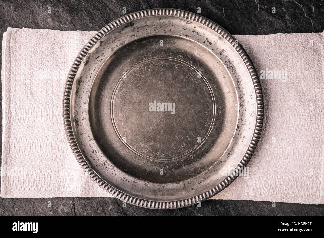 Metal plate on the dark stone table top view Stock Photo - Alamy
