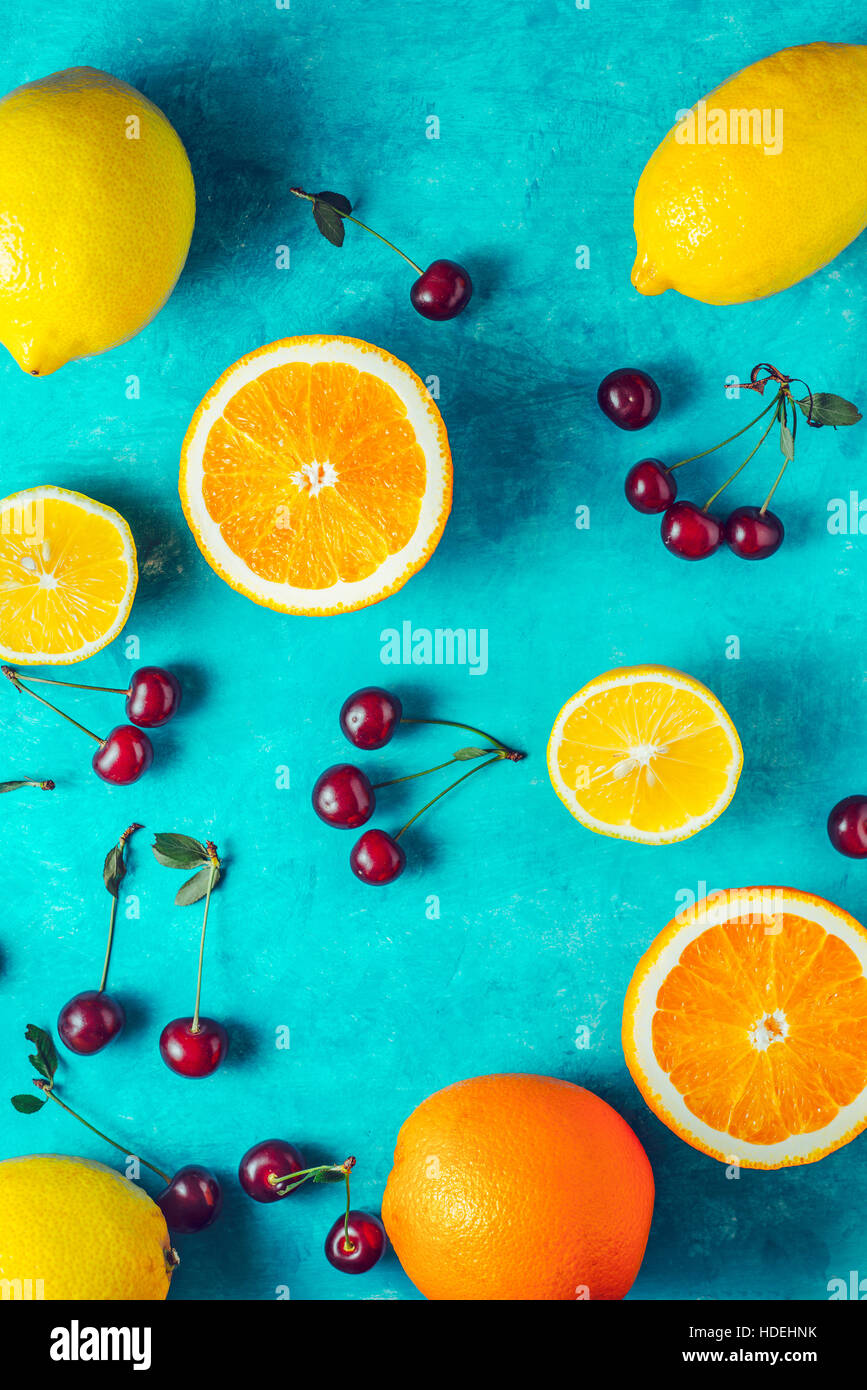 Fruit mix on the cyan background vertical Stock Photo - Alamy