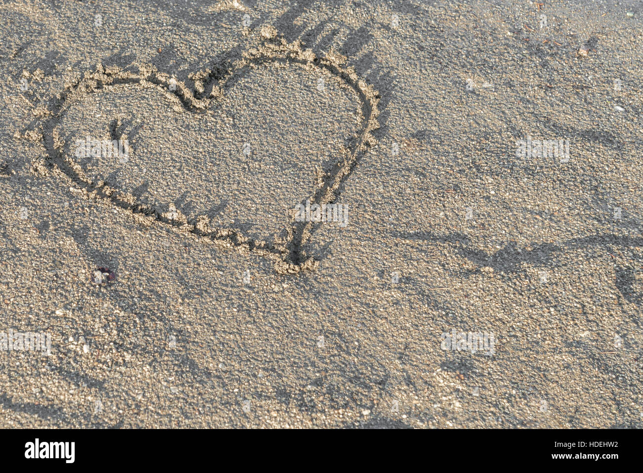 Heart in wet sand Stock Photo - Alamy