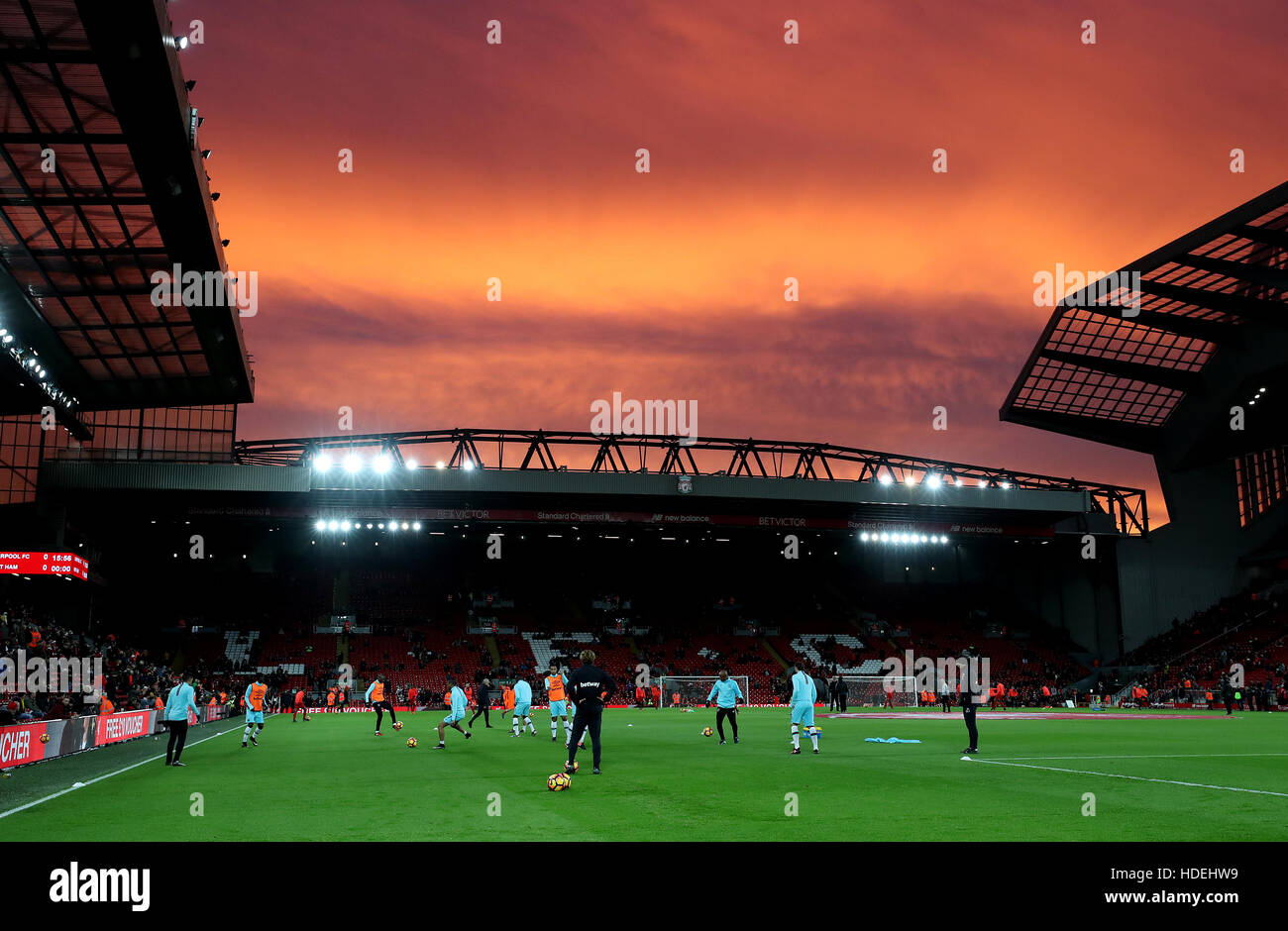 The sun begins to set over the ground as the players warm up before the ...