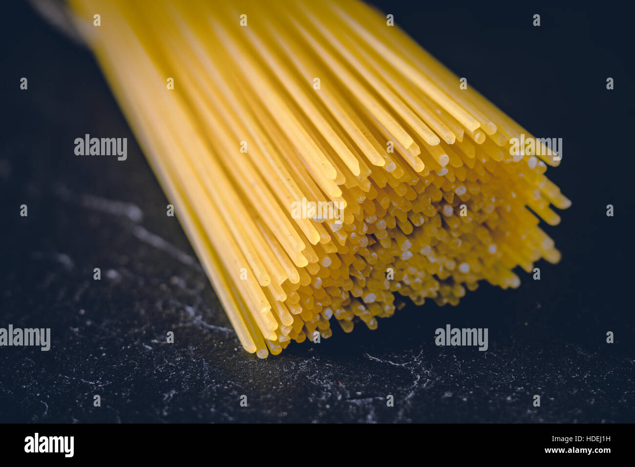 Raw spaghetti on the black stone background horizontal Stock Photo - Alamy