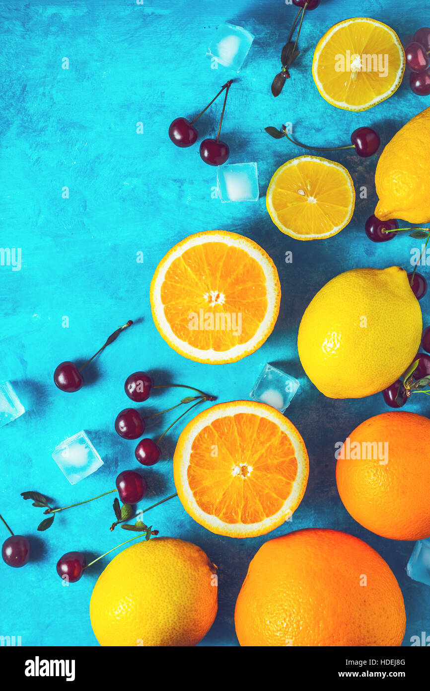 Assorted fruit on the cyan background vertical Stock Photo - Alamy