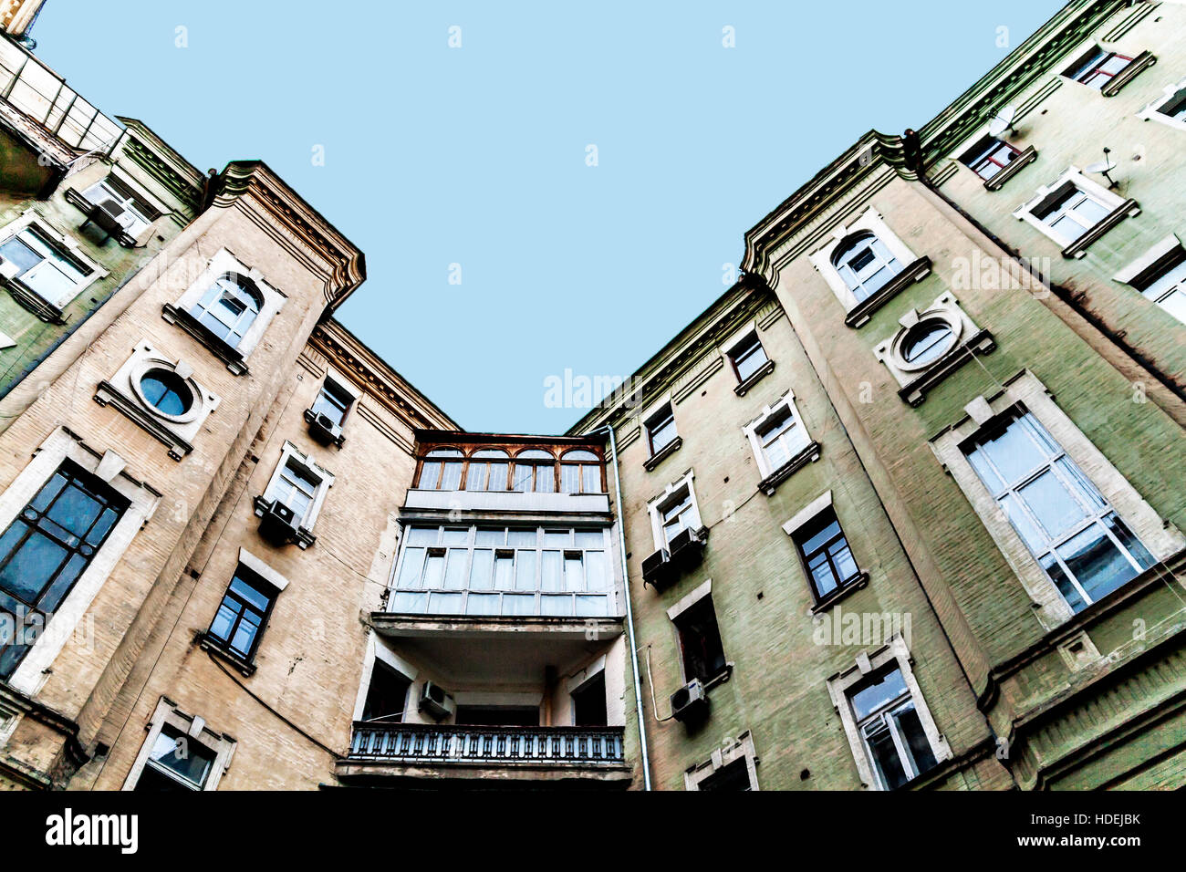 view from the bottom up at the sky, tall old houses, wells, balconies ...