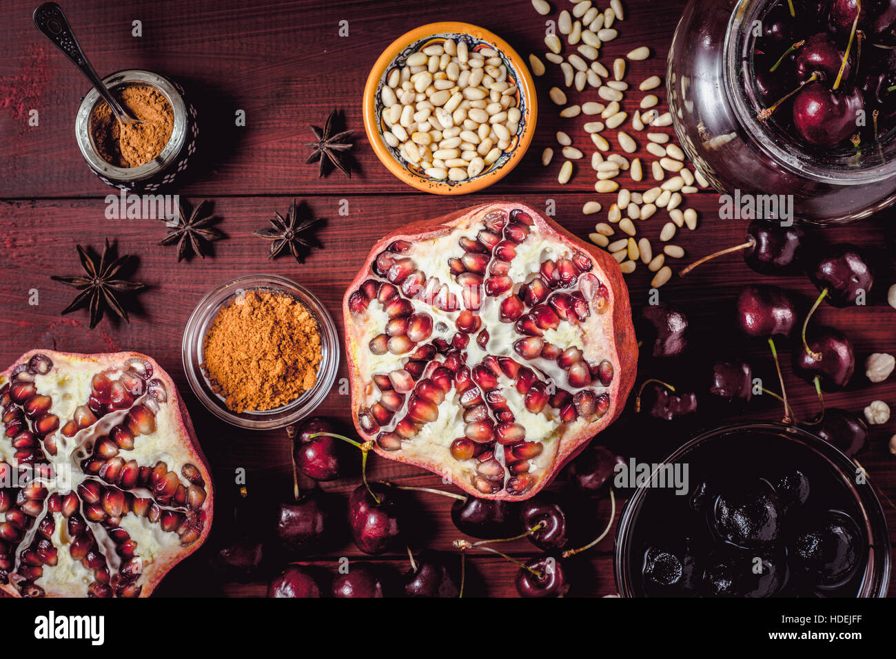 Different fruit and spices on the red wooden table. Concept of oriental ...