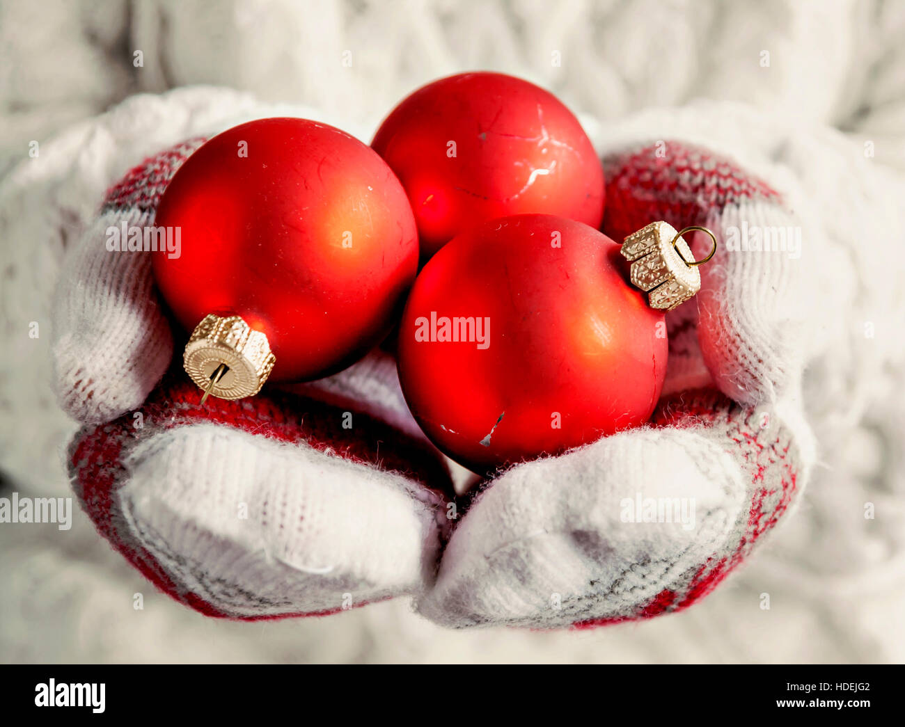 hands in mittens holding red vintage christmas balls close-up Stock ...
