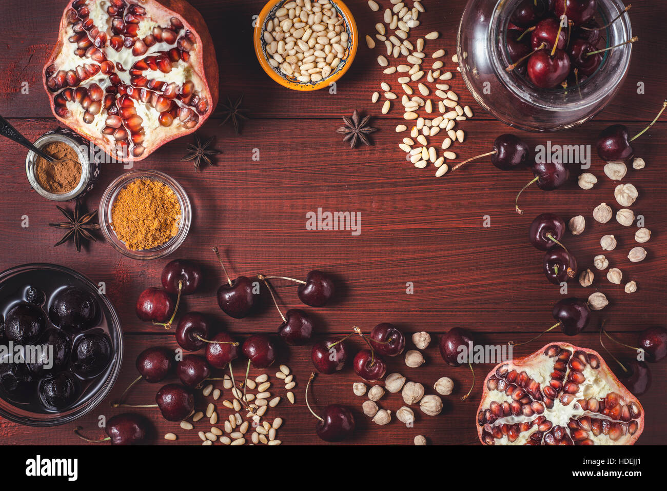 Different fruit and spices on the red wooden table. Concept of oriental ...