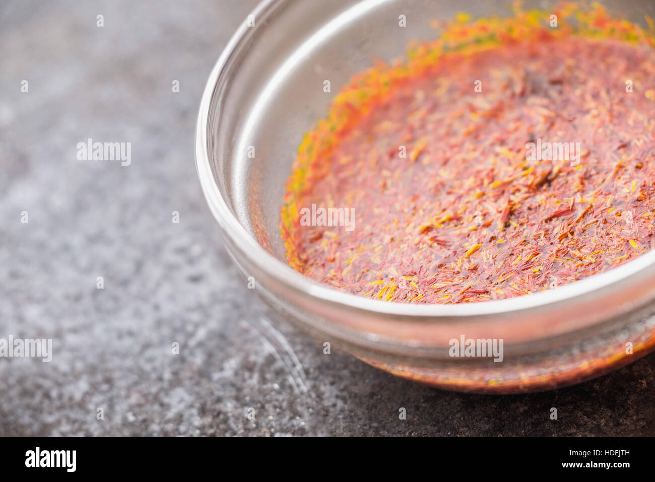 Saffron in the glass bowl on the stone table Stock Photo - Alamy