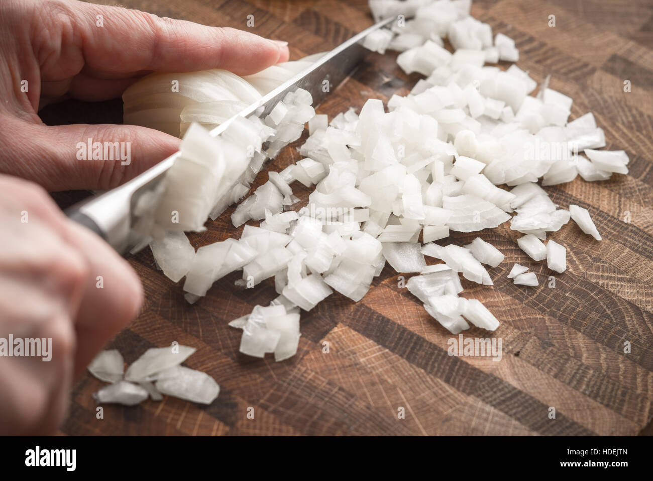 Cutting onion on the wooden board horizontal Stock Photo - Alamy