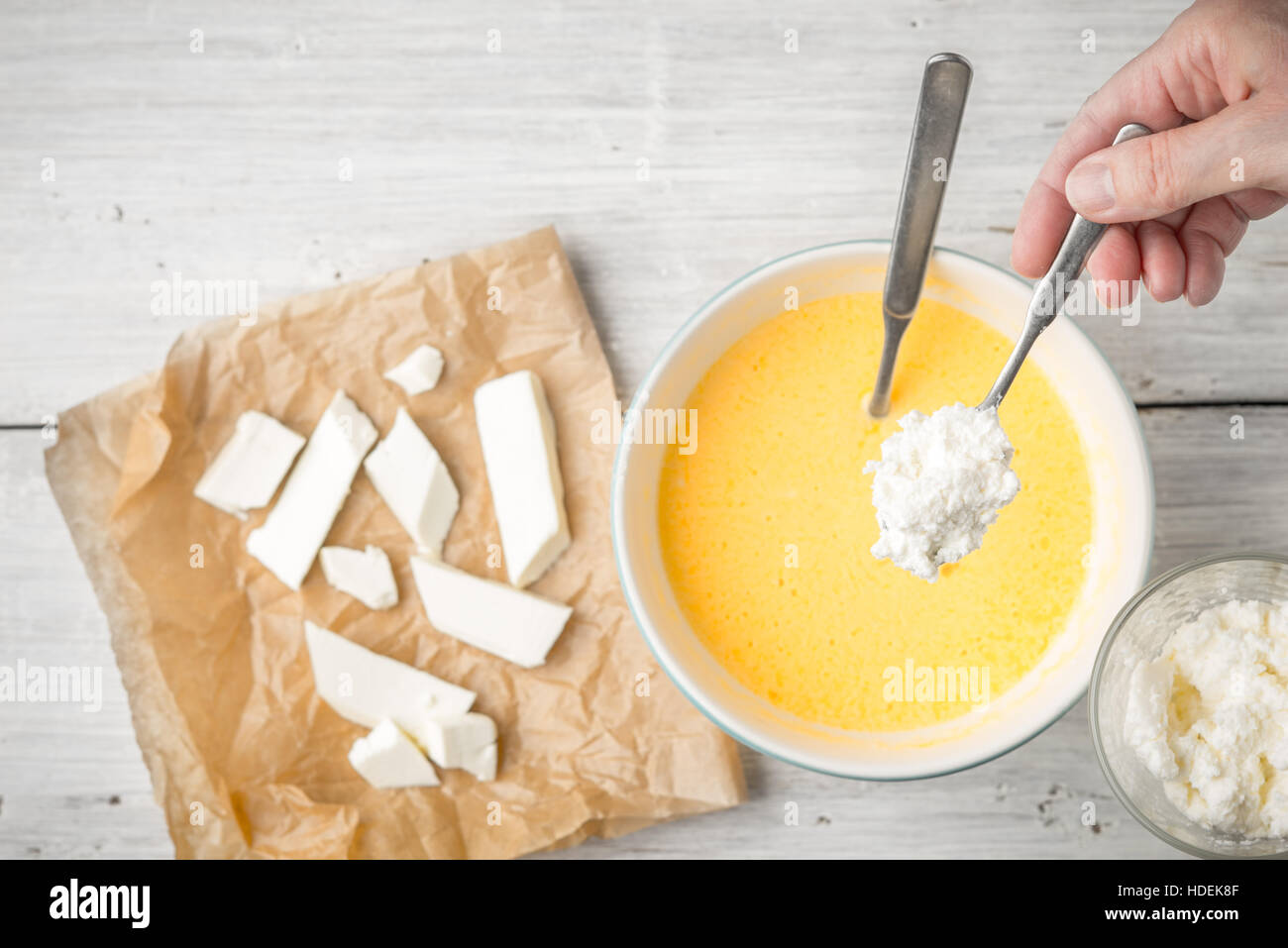 Adding cheese in the egg sauce top view Stock Photo - Alamy