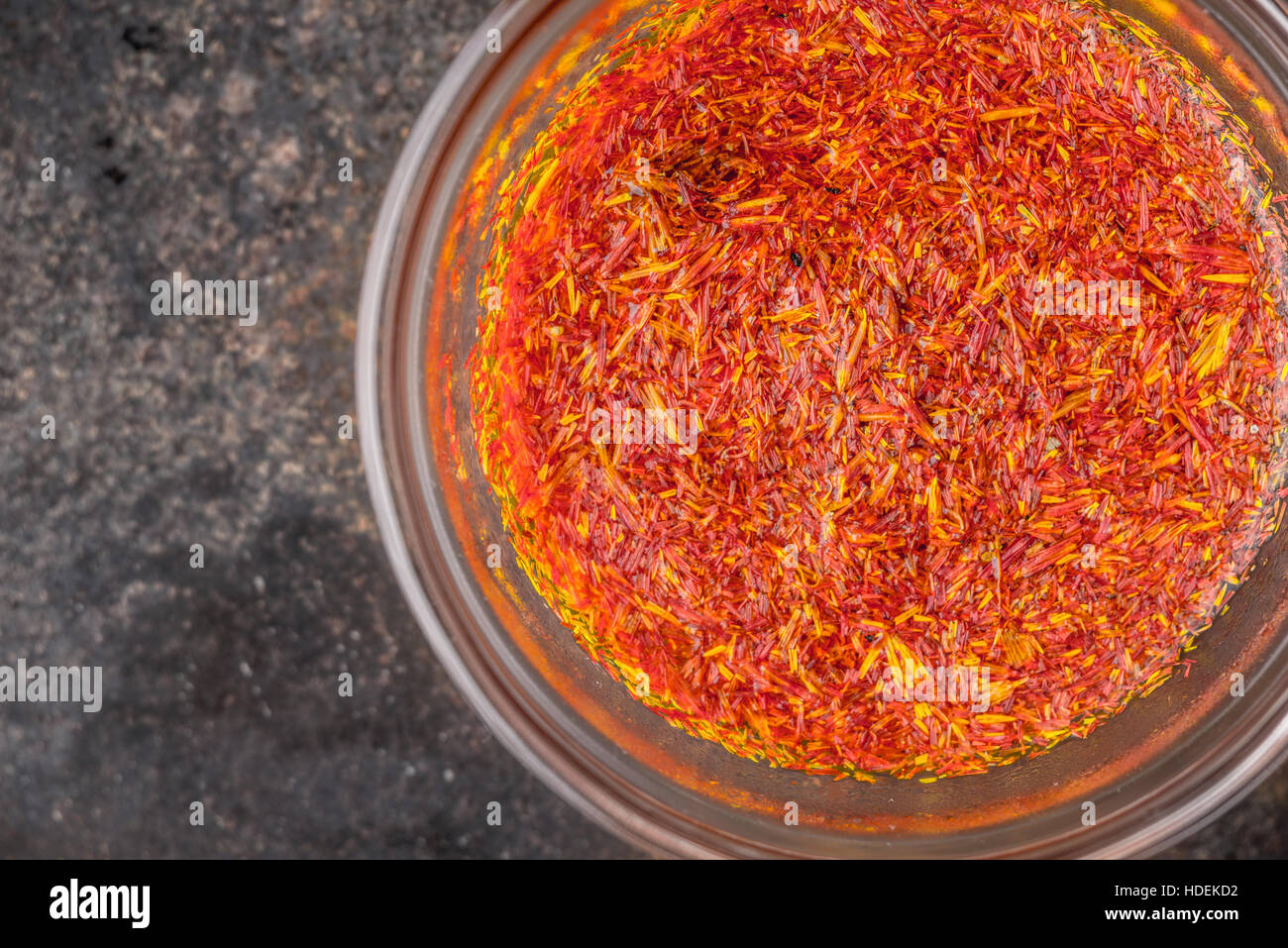 Saffron in the glass bowl top view Stock Photo - Alamy