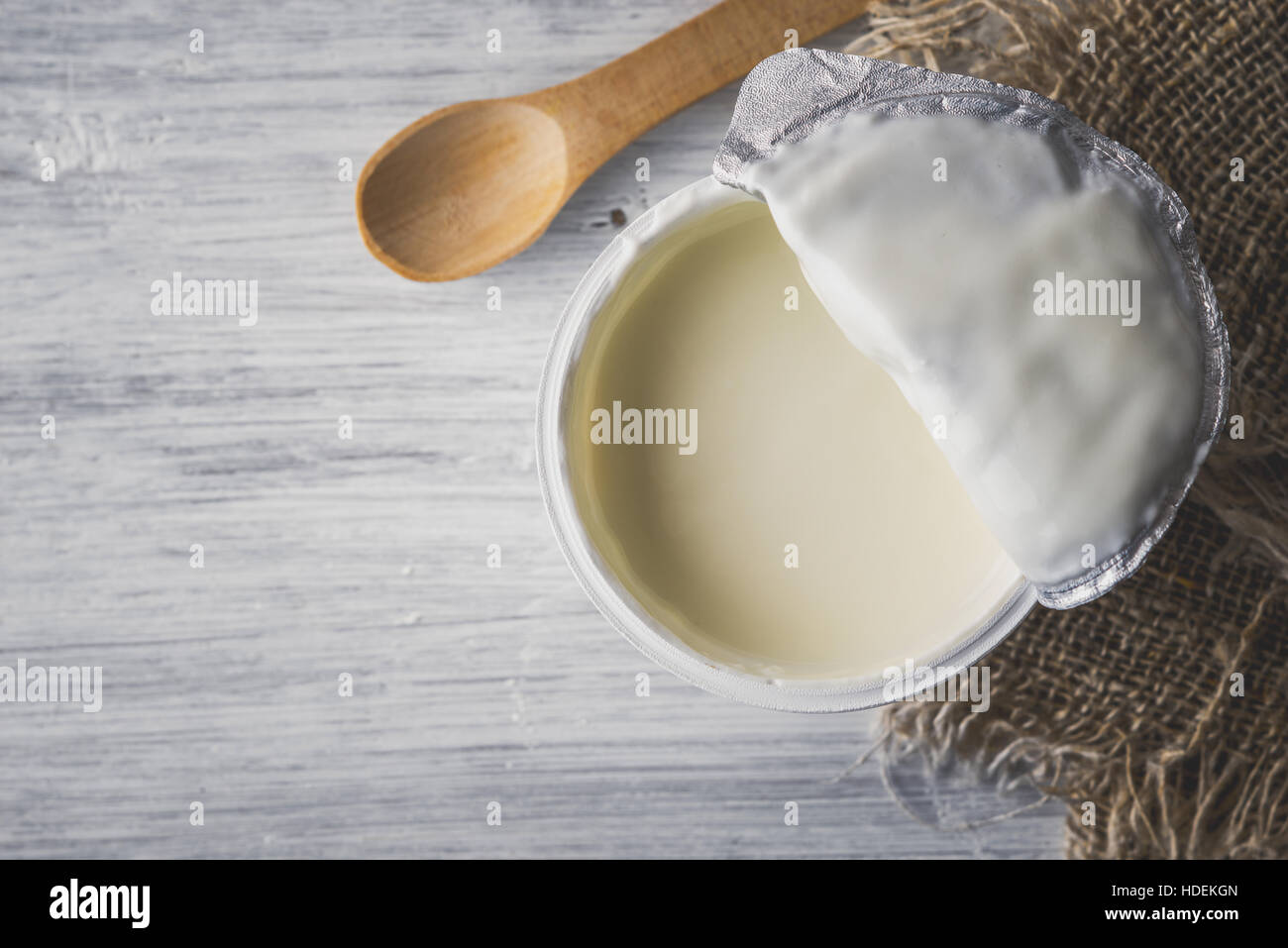 Natural yogurt on the white wooden table top view Stock Photo - Alamy