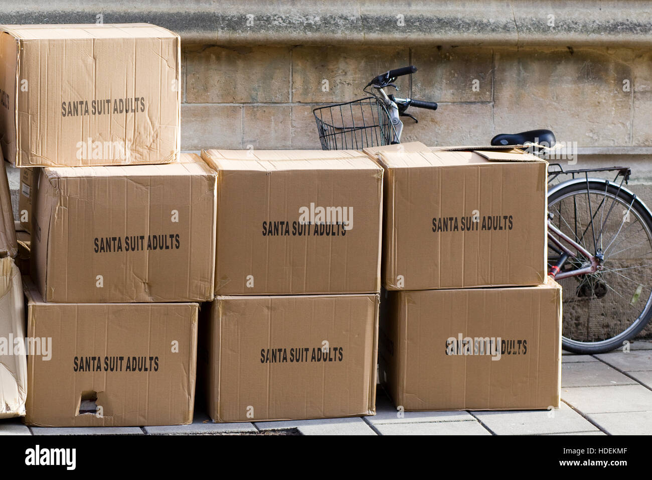 Boxes of Adult Santa Suits and a bicycle Stock Photo - Alamy