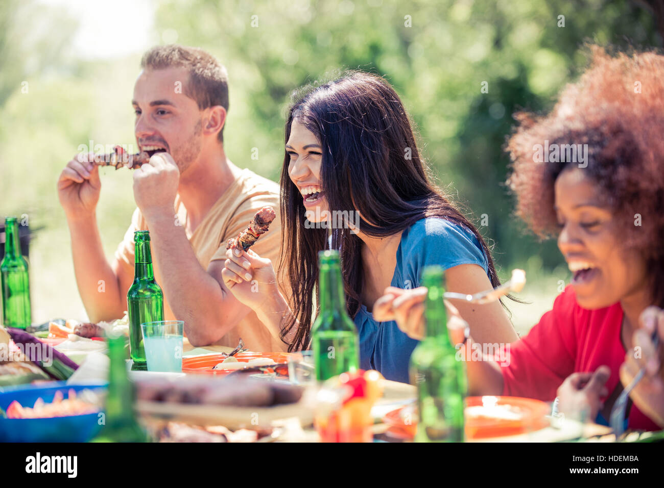 Multicultural group of friends grilling and having party in the ...
