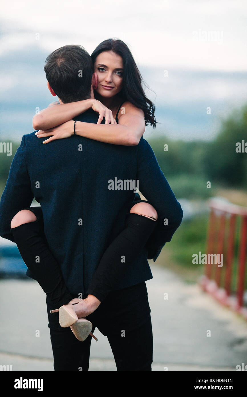 man holding his girlfriend on hands Stock Photo - Alamy