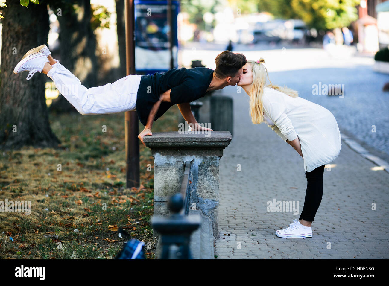 man performs an acrobatic trick near a girl Stock Photo - Alamy