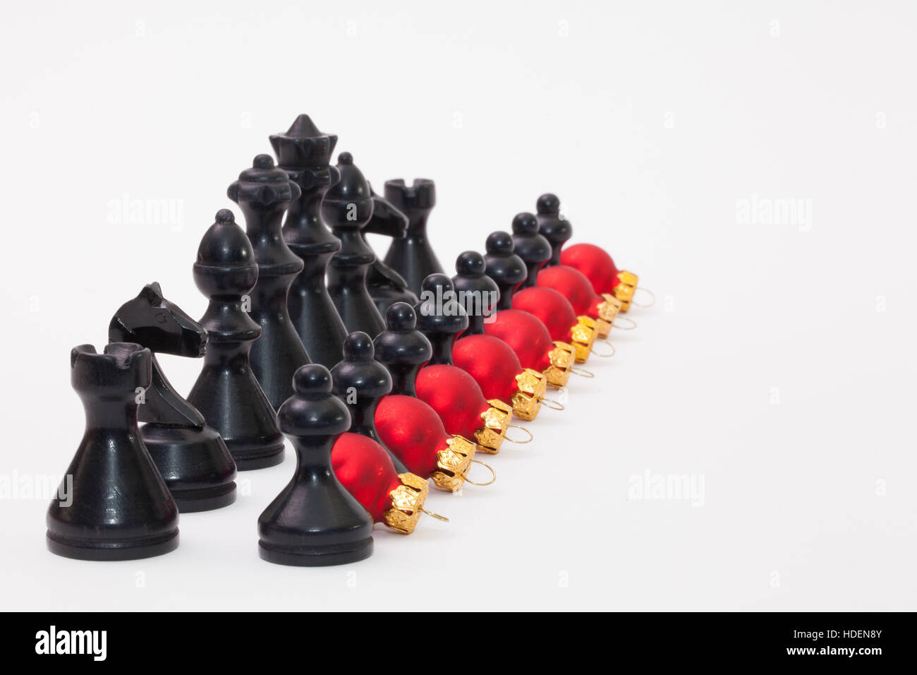 Black chess figure and red Christmas decoration on the white background ...