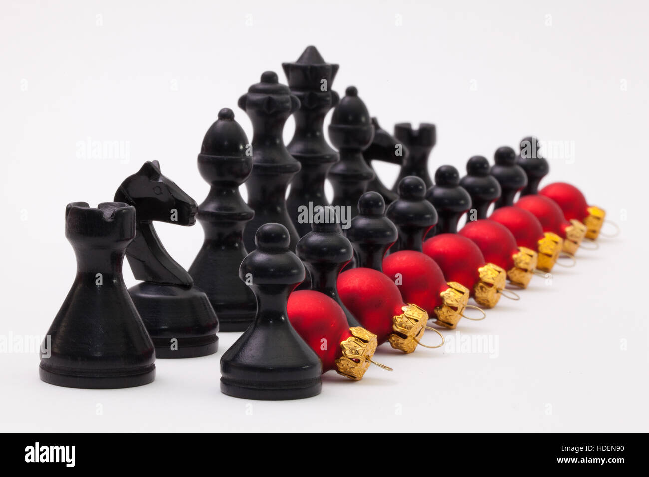 Black chess figure and red Christmas decoration on the white background ...
