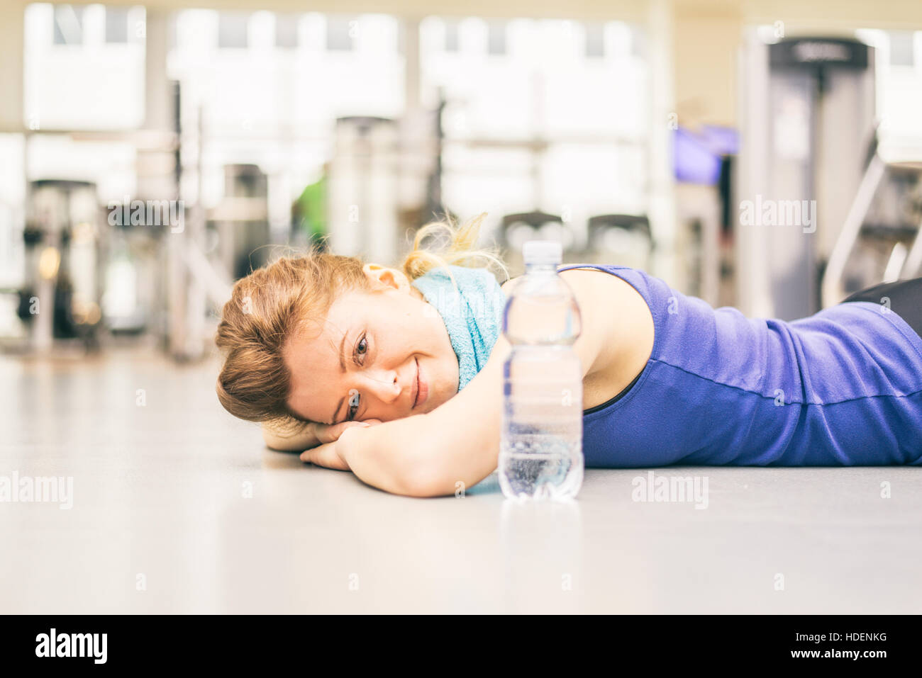 Exhausted sportive woman relaxing after a fitness workout session ...