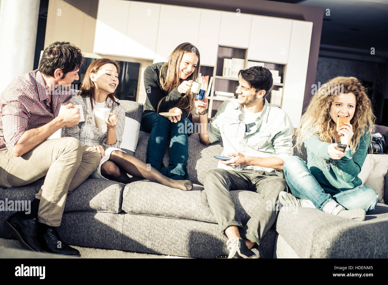 Group of friends talking and having fun while sitting on the couch ...
