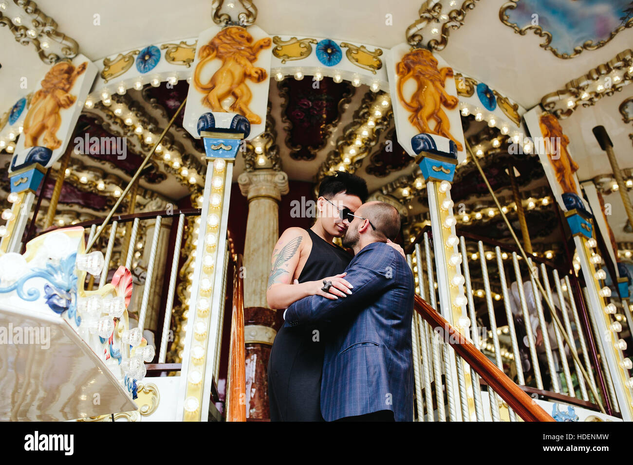 Adult man and woman on merry go round carousel hi-res stock photography ...