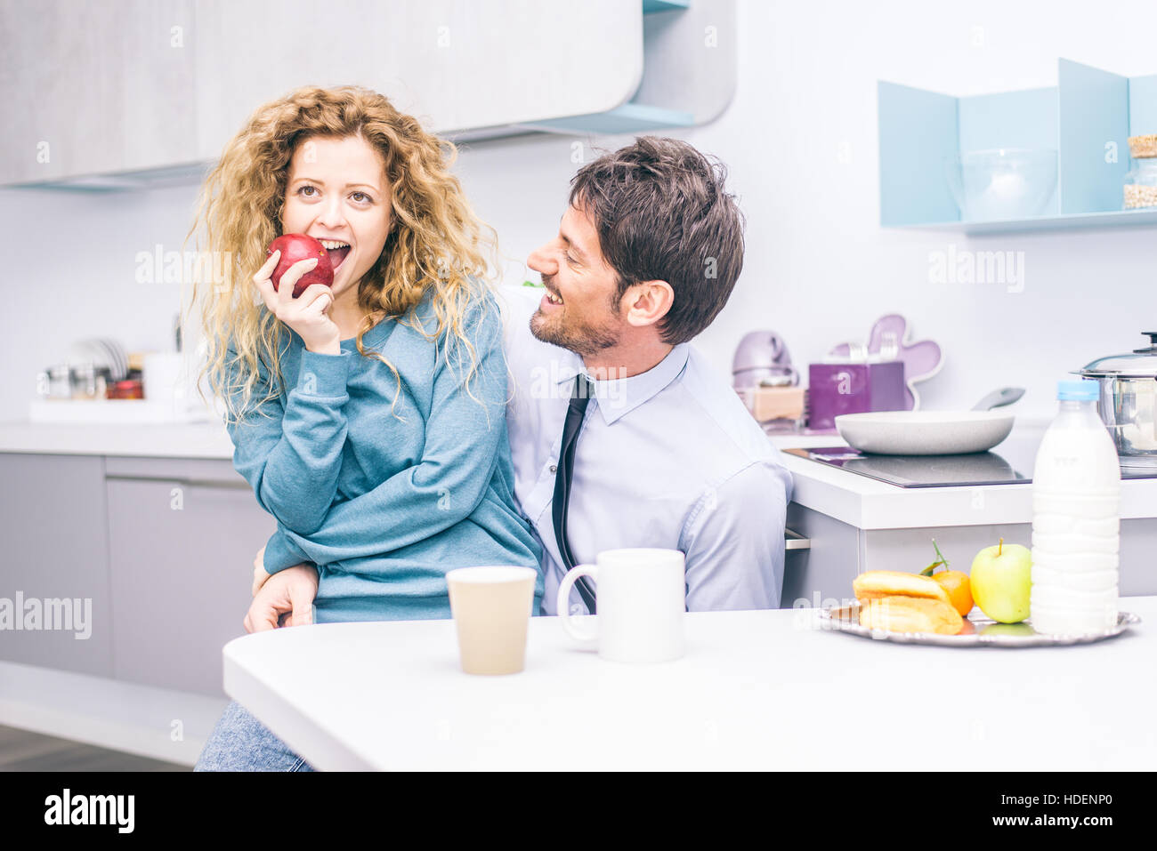 Portrait of cheerful couple making breakfast at home - Family having ...