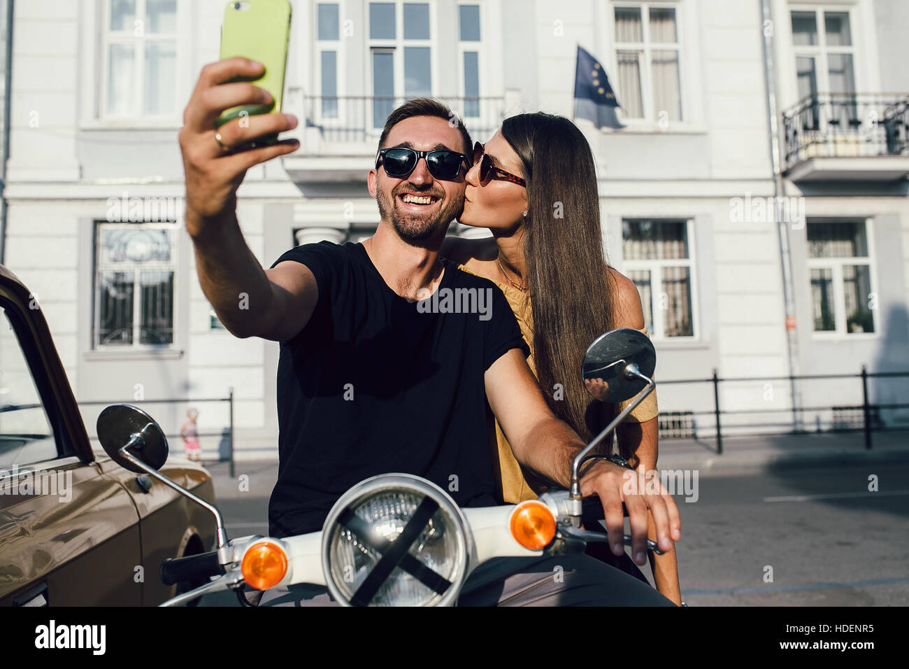 Cute couple make selfie on a scooter Stock Photo - Alamy
