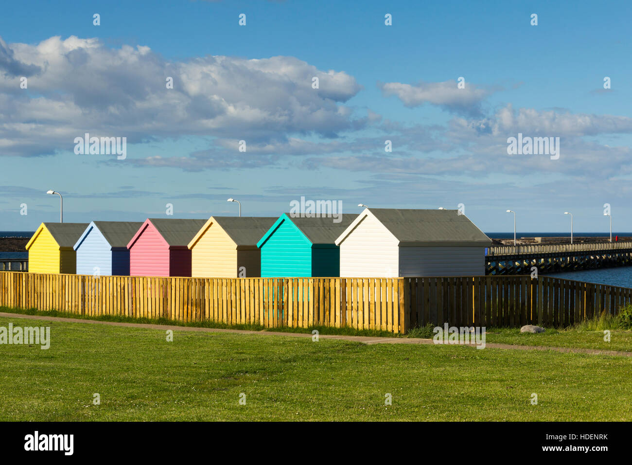 Colourful beach huts on the seafront at Amble, Northumberland, adjacent ...