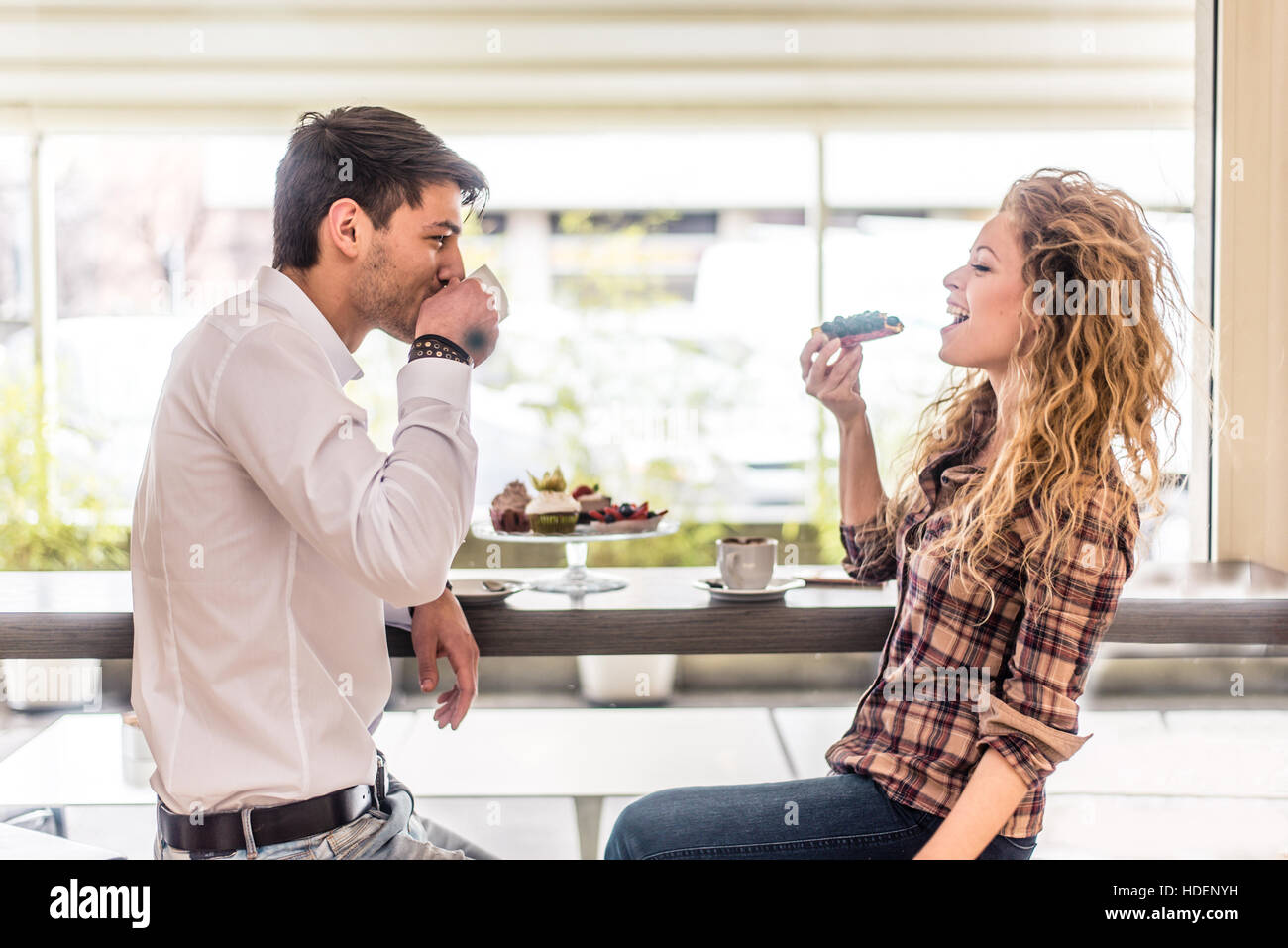 Couple having breakfast in a cafe' - Two friends meeting in a coffee ...