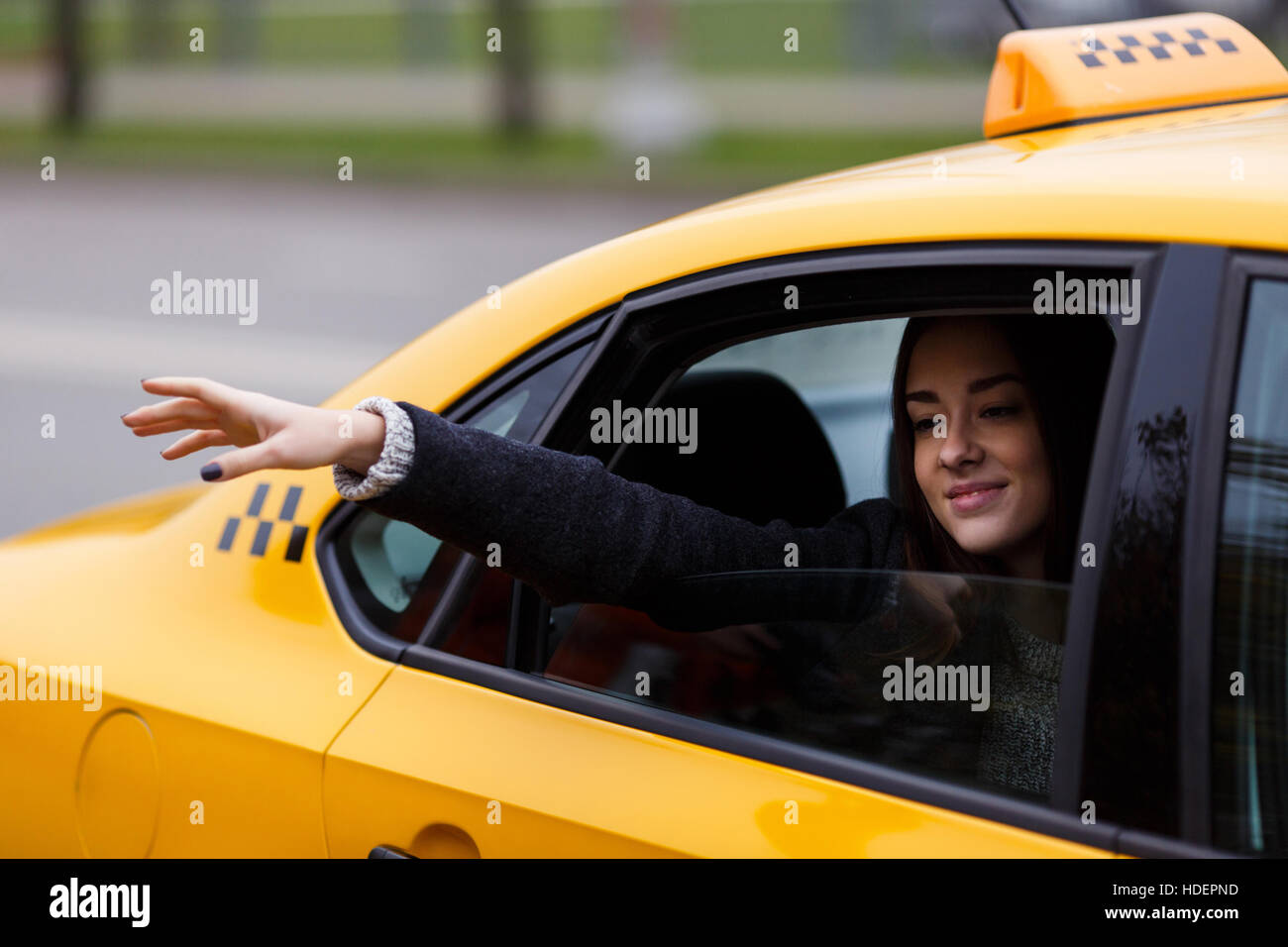 Woman extends hand taxi Stock Photo - Alamy
