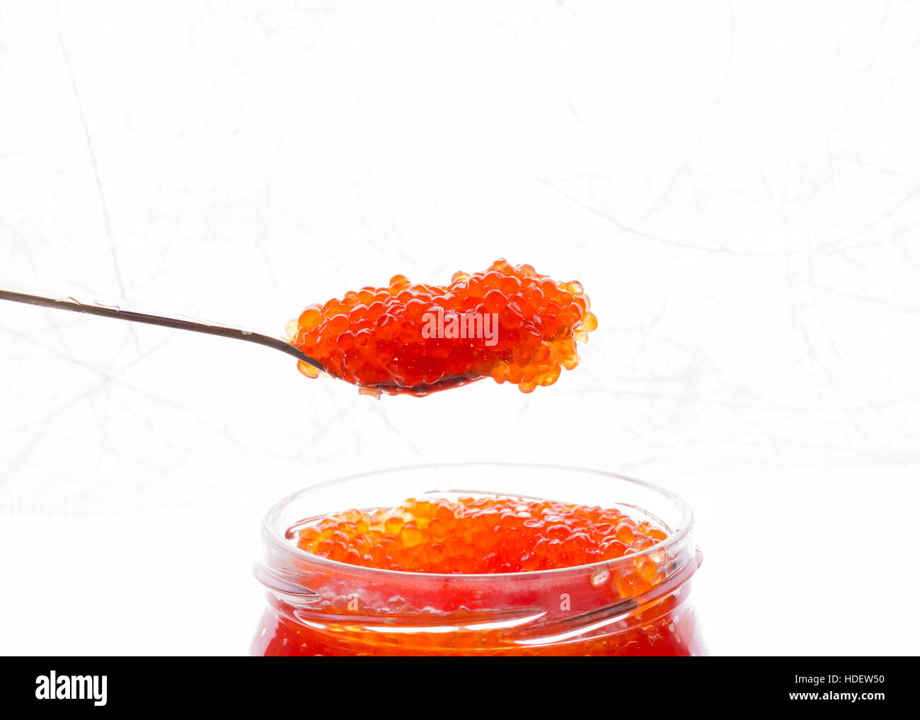 Spoon the red, delicious, juicy roe over the bank. Behind textured ...