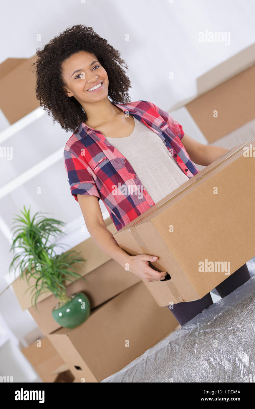 a woman is carrying a heavy cardboard Stock Photo - Alamy