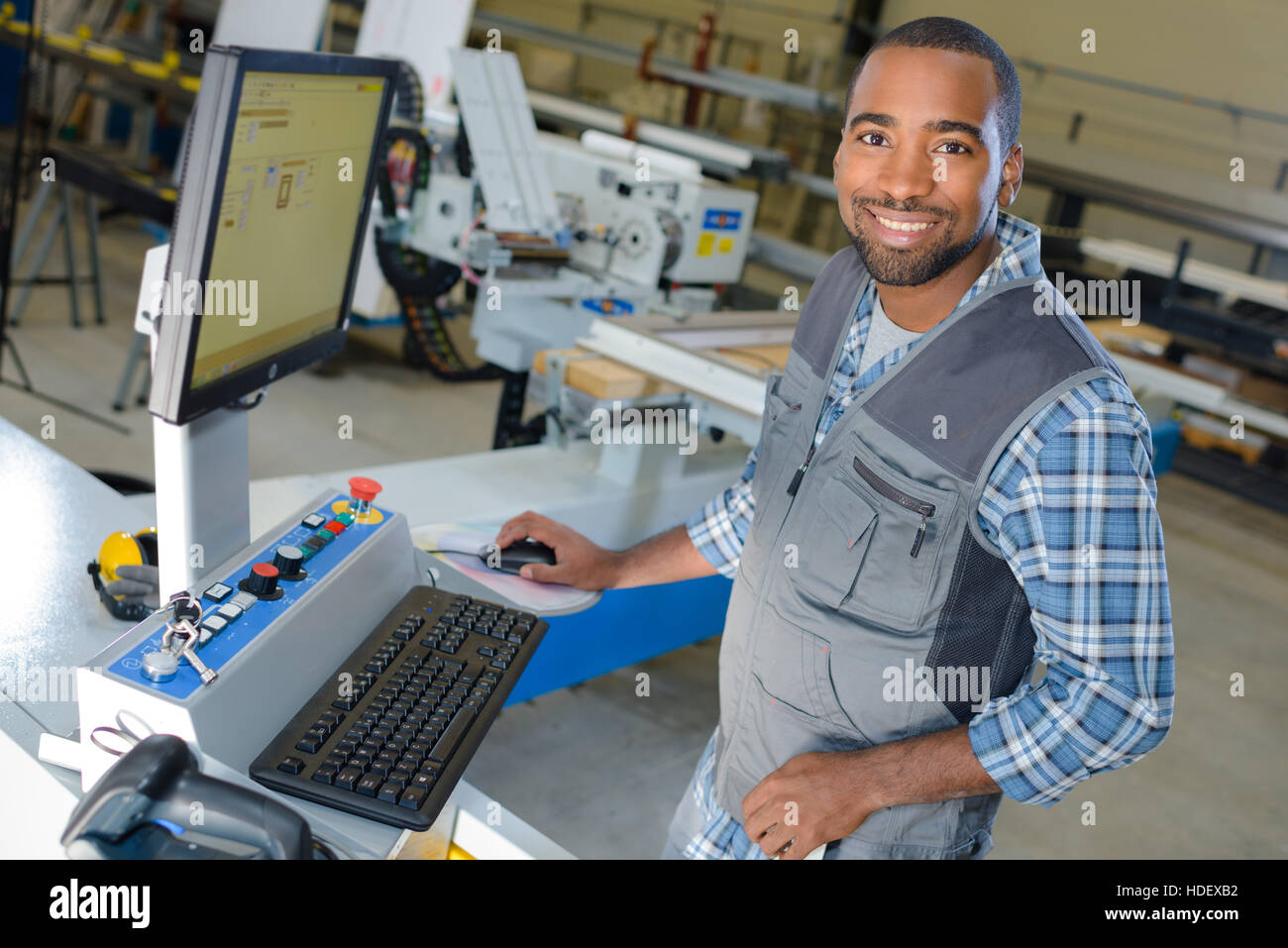 Portrait of man at electronic control desk Stock Photo - Alamy