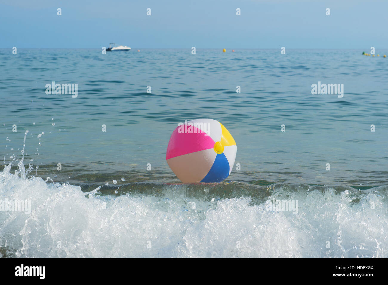 Colorful inflatable beach ball playing with the surf and the sea Stock ...