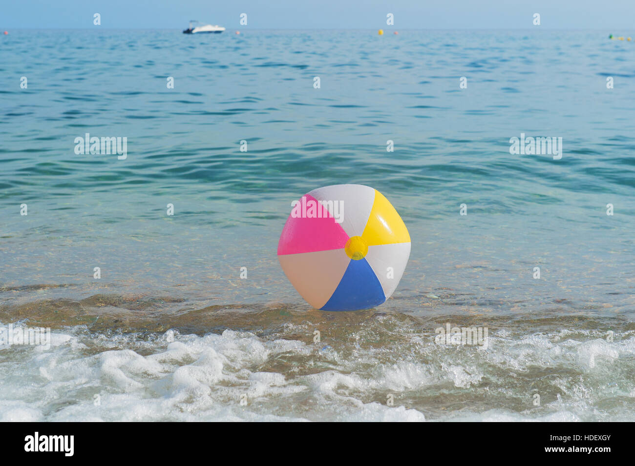 Colorful inflatable beach ball playing with the surf and the sea Stock ...