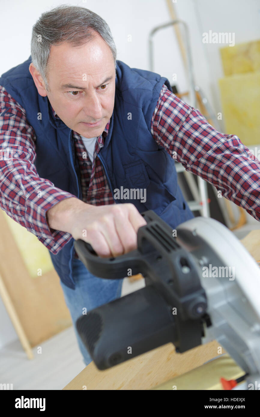 carpenter use electric saw Stock Photo - Alamy