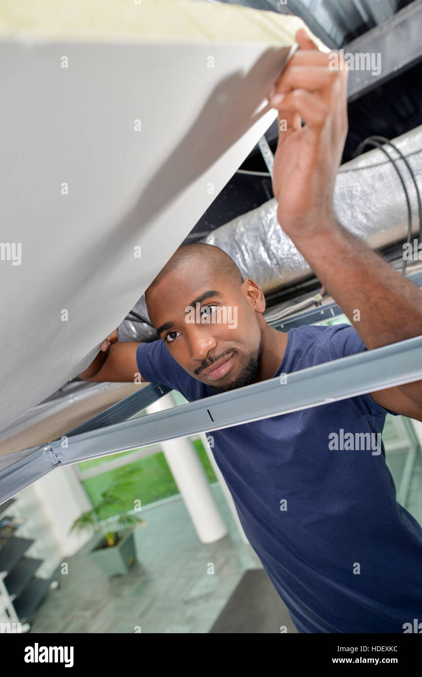 Lifting up a ceiling panel Stock Photo - Alamy