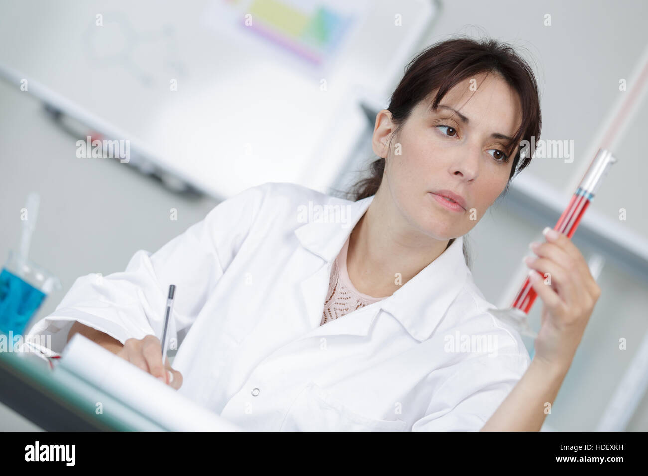 female laboratory researcher holding flask Stock Photo - Alamy