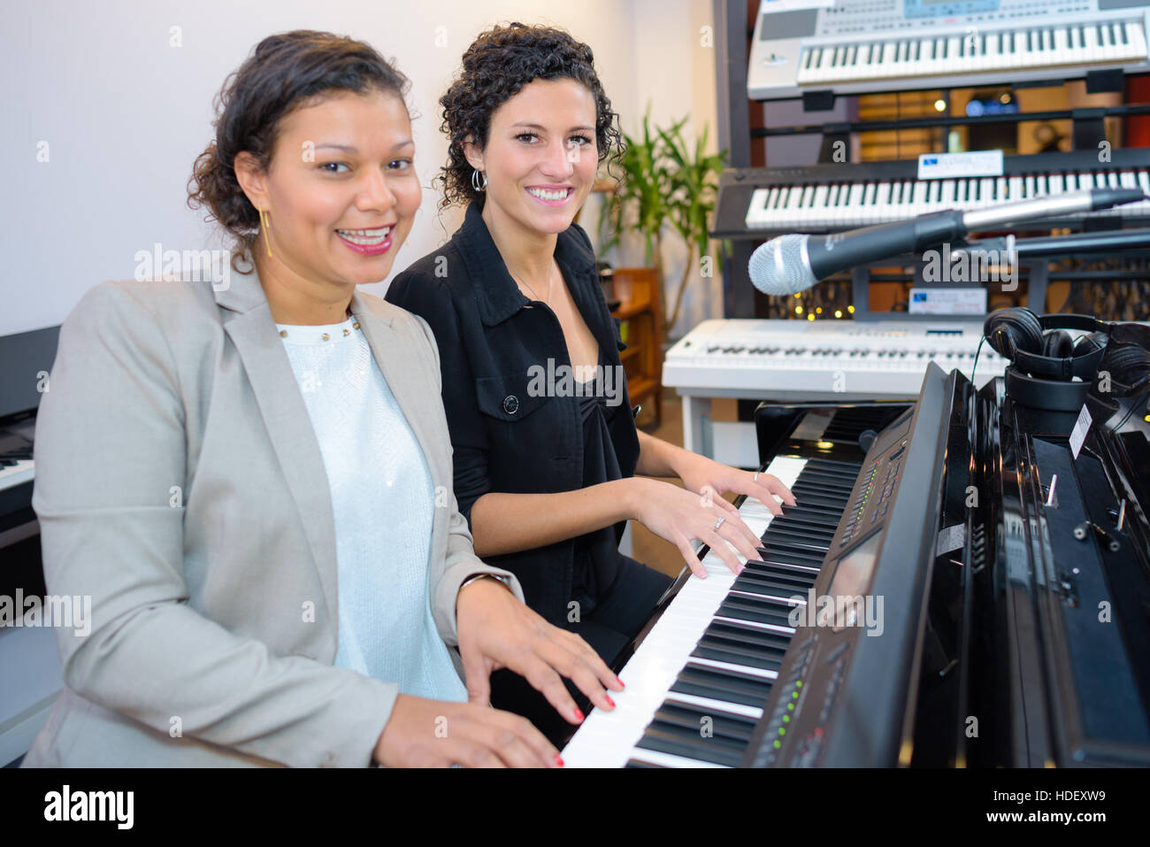 Two women at organ keyboard Stock Photo - Alamy