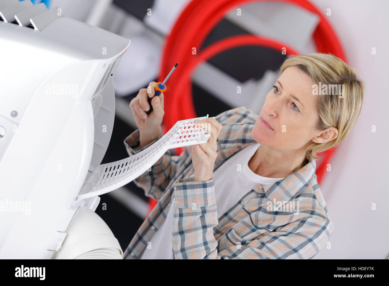 woman worker fixing an appliance Stock Photo - Alamy