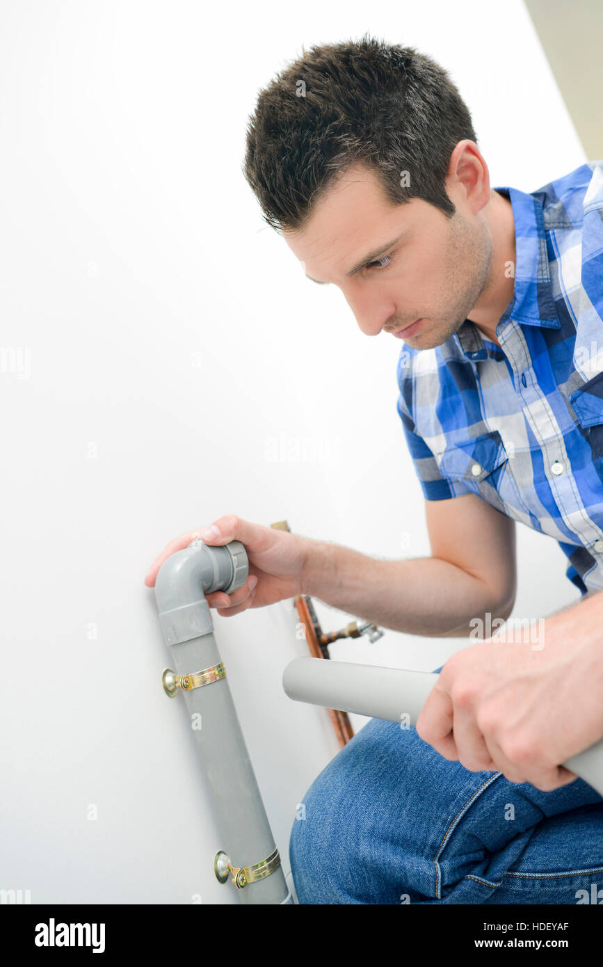Man fitting pvc pipes Stock Photo - Alamy