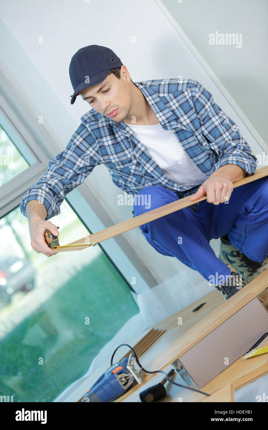 young technician installing floor at construction site Stock Photo - Alamy