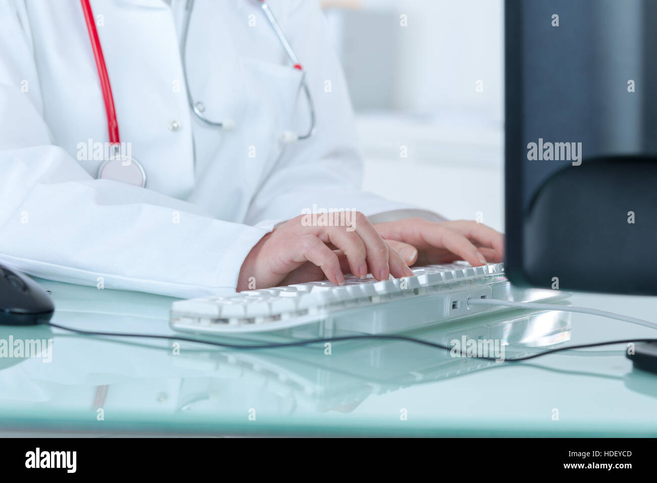female doctor sitting at the desk Stock Photo - Alamy
